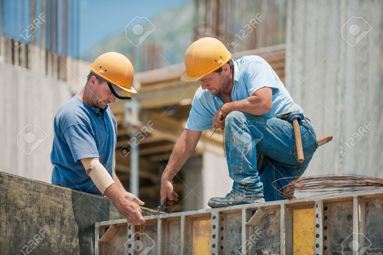 15815507-two-authentic-construction-workers-collaborating-in-the ...
